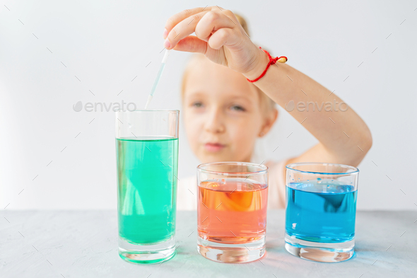 cute little girl six years old doing laboratory experiment with ...