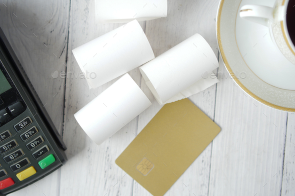 POS machine and long roll paper on blue . Stock Photo by towfiqu98
