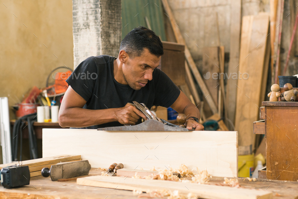 Work: Latin American worker in his workshop using different tools ...