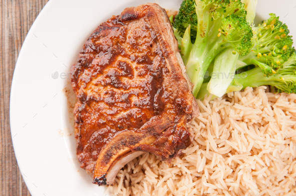 bbq pork chop with brown rice Stock Photo by wirestock | PhotoDune