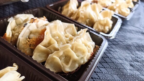 Many Japanese street food snack yoza on dark plastic tray for little ...