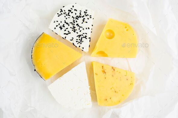 Set of different cheeses cut in triangles isolated on the white ...