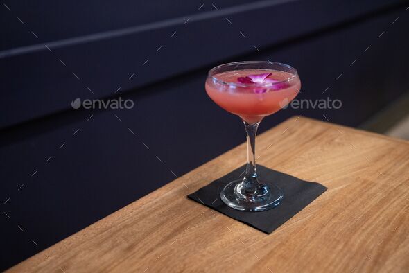 Beautiful cocktail of guava hibiscus martini with orchid garnish Stock ...