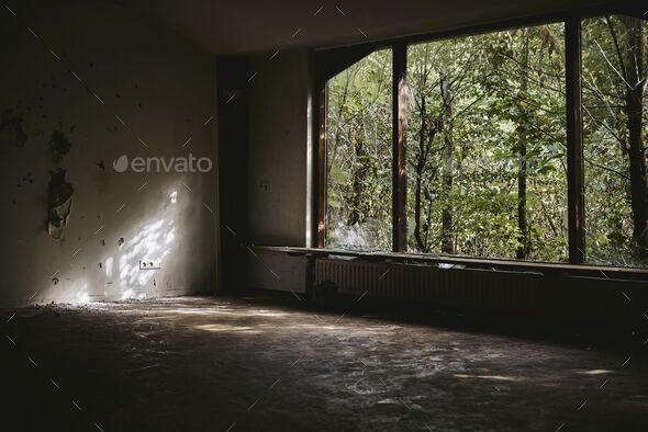 Old, dirty, abandoned building interior. Dirty room with wide windows ...