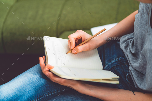 Top down view unrecognizable woman writing in her notebook Stock Photo ...