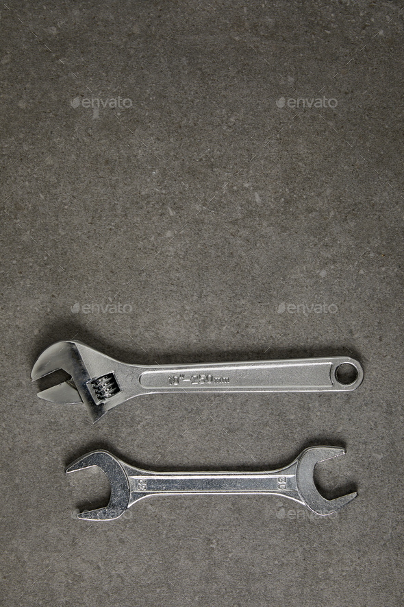 top view of adjustable wrench and spanner on gray surface Stock Photo ...