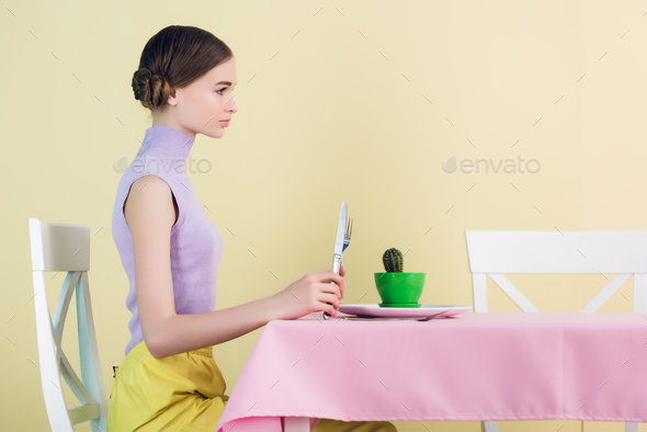 side view of girl eating cactus with fork and knife, diet concept Stock ...