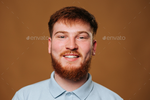 In this stunning studio portrait, a teenage boy with bright red hair ...