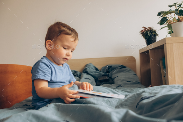child reading a book to her daughter before nap Stock Photo by Bagler_kat