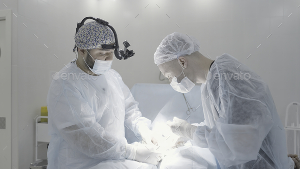 Surgeons work during operation. Action. Two professional surgeons are ...