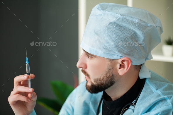Doctor comes into a solution for injection in a syringe Stock Photo by ...