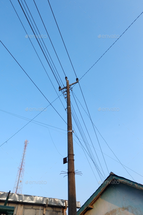 Inclined shot of an electrical power pole with wires connecting to it ...