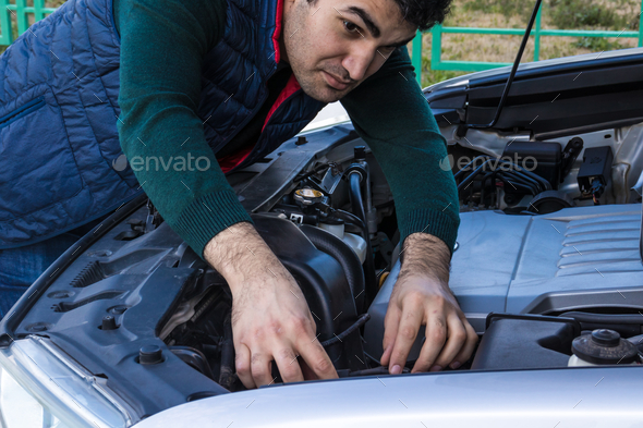 Turkmen man repairing a broken car Stock Photo by wirestock | PhotoDune