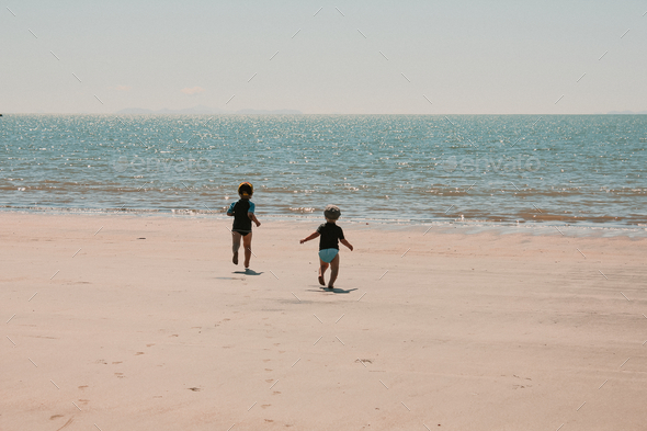 Back view of two boys on the beach Stock Photo by wirestock | PhotoDune