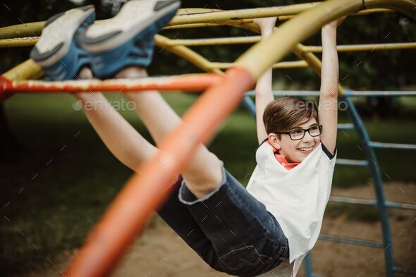Young teen boy playing in a park with sports equipment Stock Photo by ...