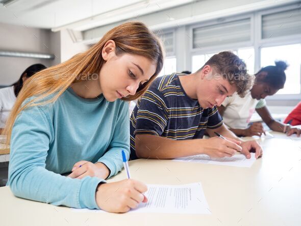 Group of students attentively taking a test in a classroom Stock Photo ...