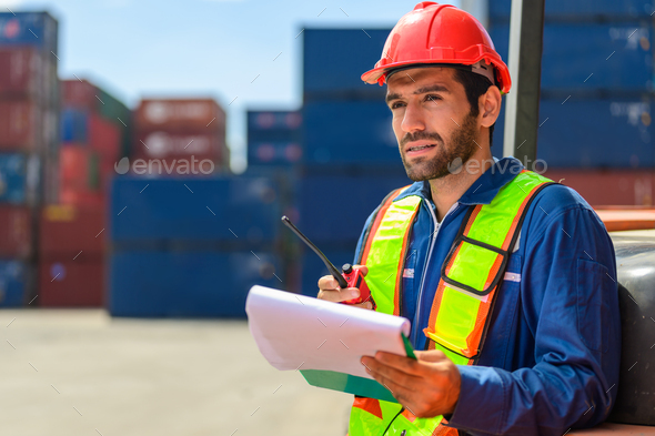 Warehouse engineer working at container yard Stock Photo by 1footage