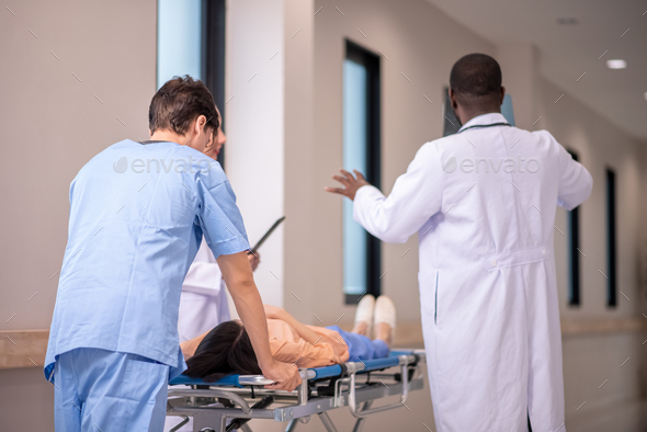 medic running with gurney along hospital corridor Stock Photo by ...