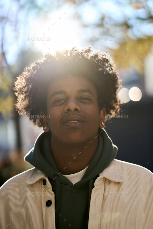 Cool young gen z hipster African American teen in sunny city park ...