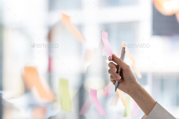 Young Asian woman Creative team use post it notes to share idea sticky ...