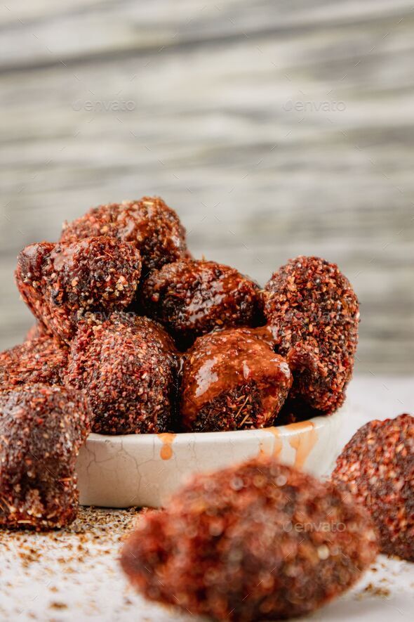 Vertical closeup of natural tamarind with chili powder and chamoy on ...