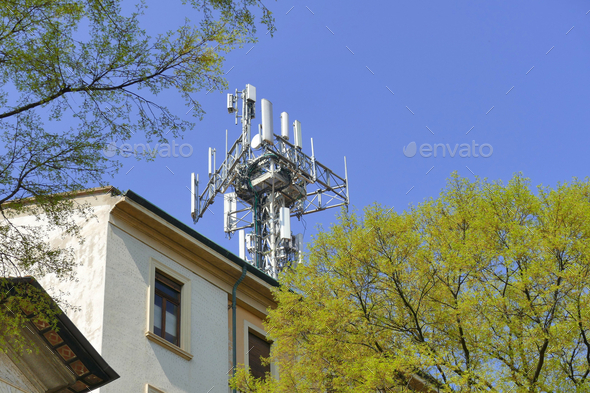 New 5G communication tower on residential building in urban scenery Stock Photo by wirestock