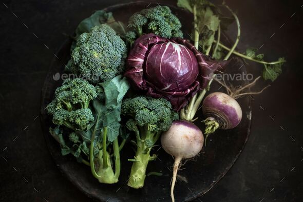 Top view of french turnips and broccoli on dark surface background ...