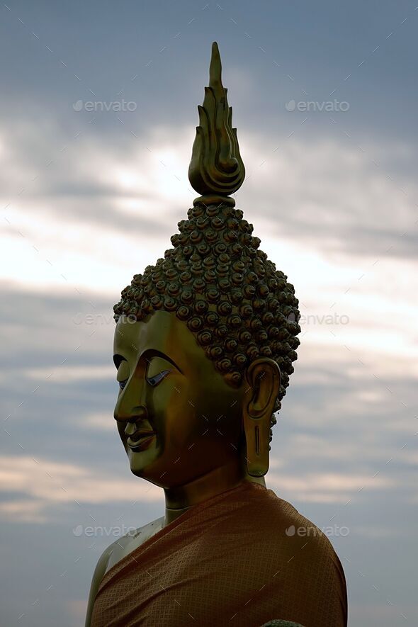 Vertical aerial view of the head of big golden Buddha statue on the top ...