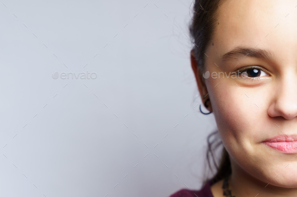 Photo of the half face of a smiling girl and a white background Stock ...