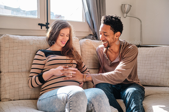 Happy pregnant couple holding their hands on belly while expecting baby ...