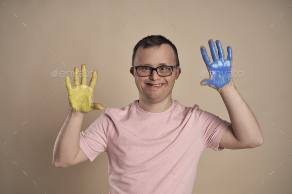Man with down syndrome with painting hands on colorful Stock Photo by ...