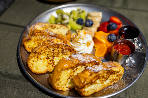 Grill toast with egg and fruit in coffee shop Stock Photo by leungchopan