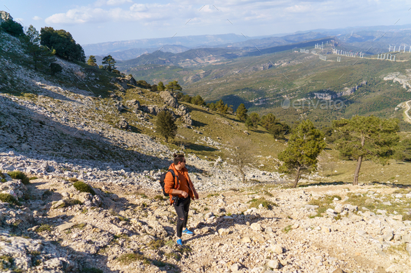 Spanish young man hiking in hills and observing the beautiful view ...