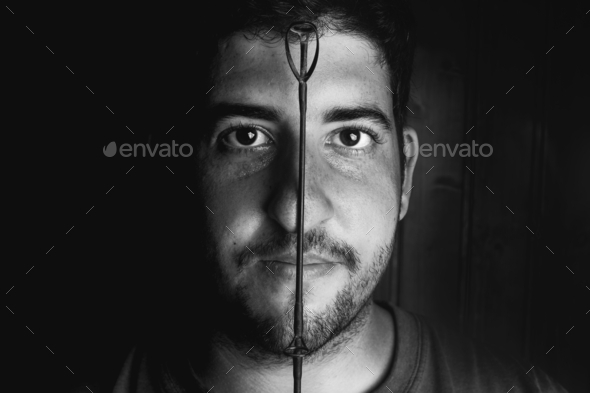 Greyscale portrait of a male with a fishing rod splitting his face into ...