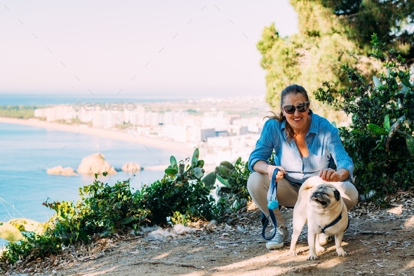 Female walking with a dog in a park with a lot of beautiful trees Stock ...