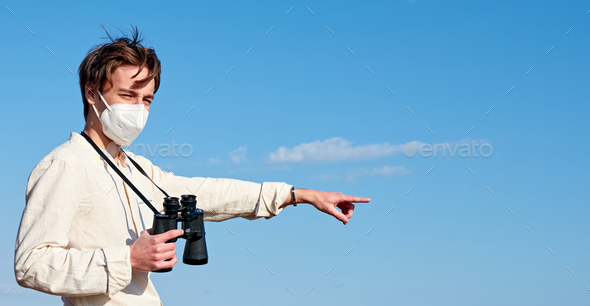Side view of a Spanish male tour guide wearing a facemask showing the ...