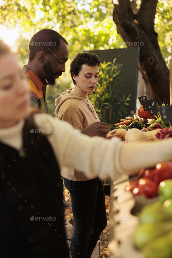 Smiling female client enjoying farm shopping experience at local food ...