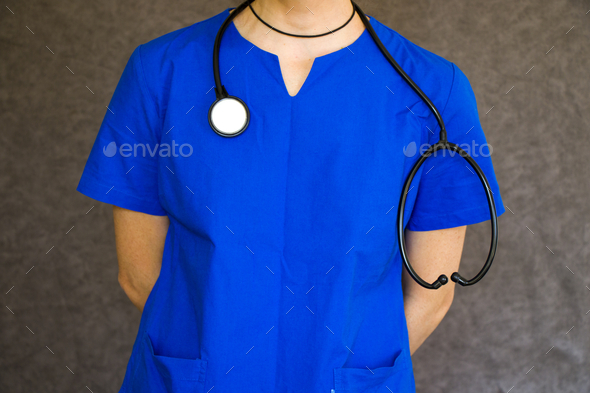 Male doctor wearing a blue uniform with a stethoscope Stock Photo by ...