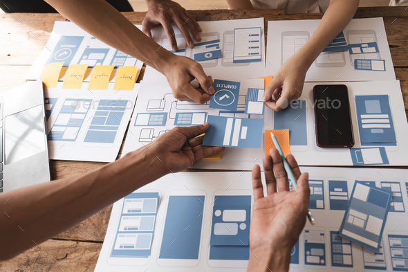 Close Up Ux Developer And Ui Designer Brainstorming About Mobile App Interface Wireframe Design