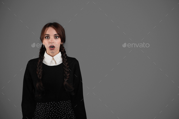 Shocked teen girl student in gothic black clothes with pigtails, open mouth look at camera Stock ...