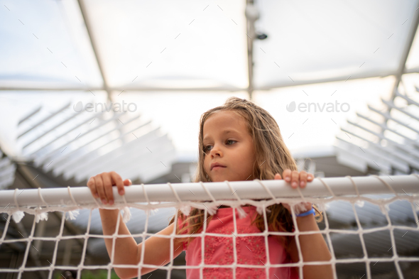 Little girl lean on net looking away Stock Photo by andreonegin | PhotoDune