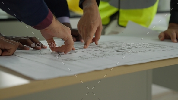 Close up blueprint, male engineer foreman using blueprint assigning ...