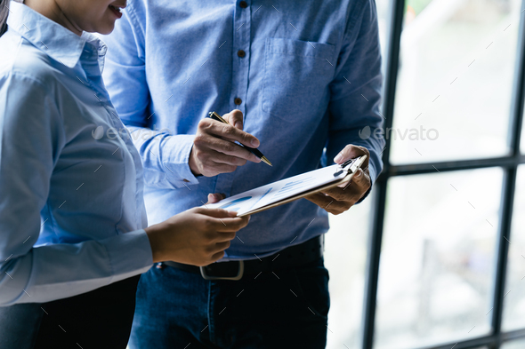 Business team reviewing a diagram or chart and financial reports Stock ...