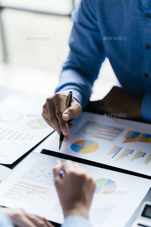 Business team reviewing a diagram or chart and financial reports Stock ...