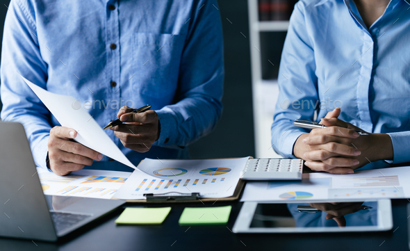 Business team reviewing a diagram or chart and financial reports Stock ...
