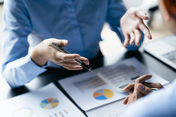 Business team reviewing a diagram or chart and financial reports Stock ...