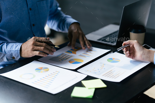 Business team reviewing a diagram or chart and financial reports Stock ...