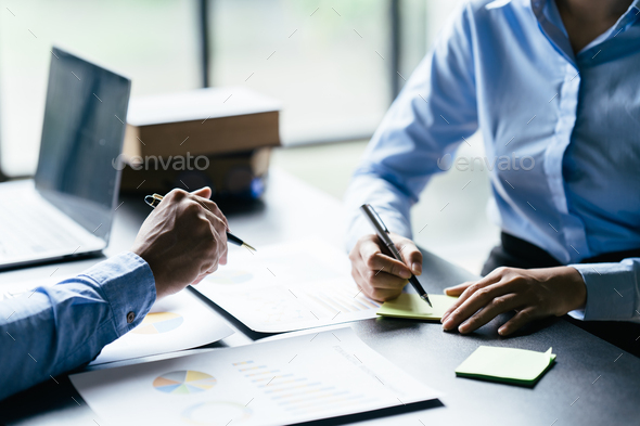 Business team reviewing a diagram or chart and financial reports Stock ...