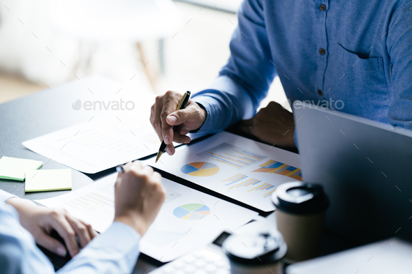 Business team reviewing a diagram or chart and financial reports Stock ...