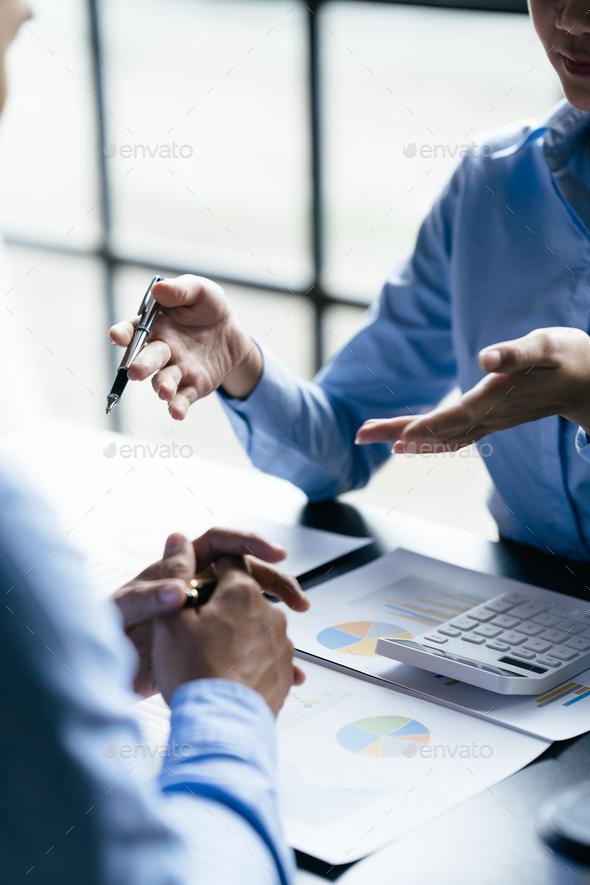 Business team reviewing a diagram or chart and financial reports Stock ...